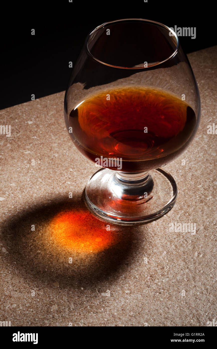 a glass of brandy on the marble table Stock Photo - Alamy