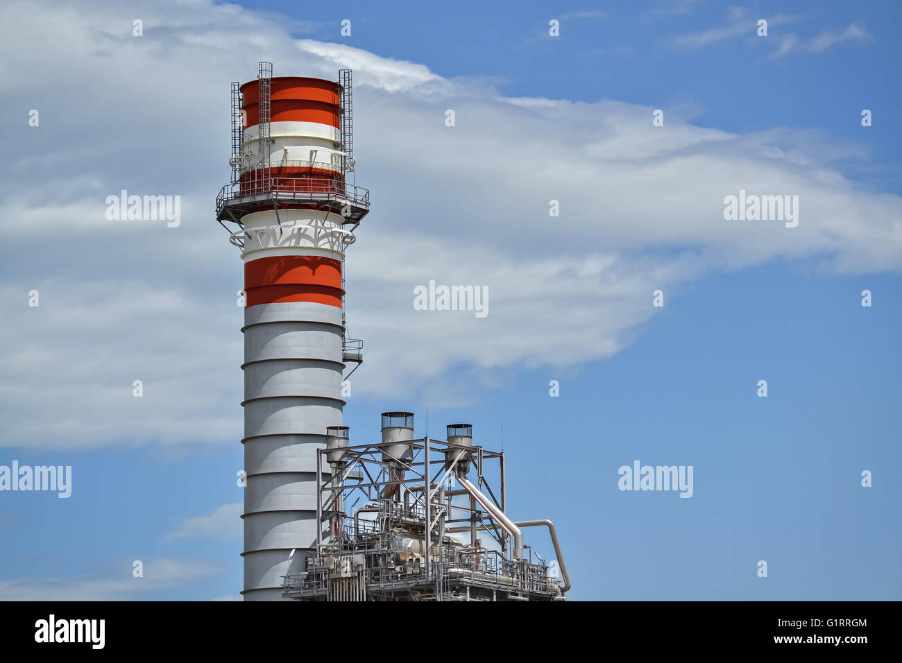 Detail of a factory with pipeline and tall chimney Stock Photo - Alamy