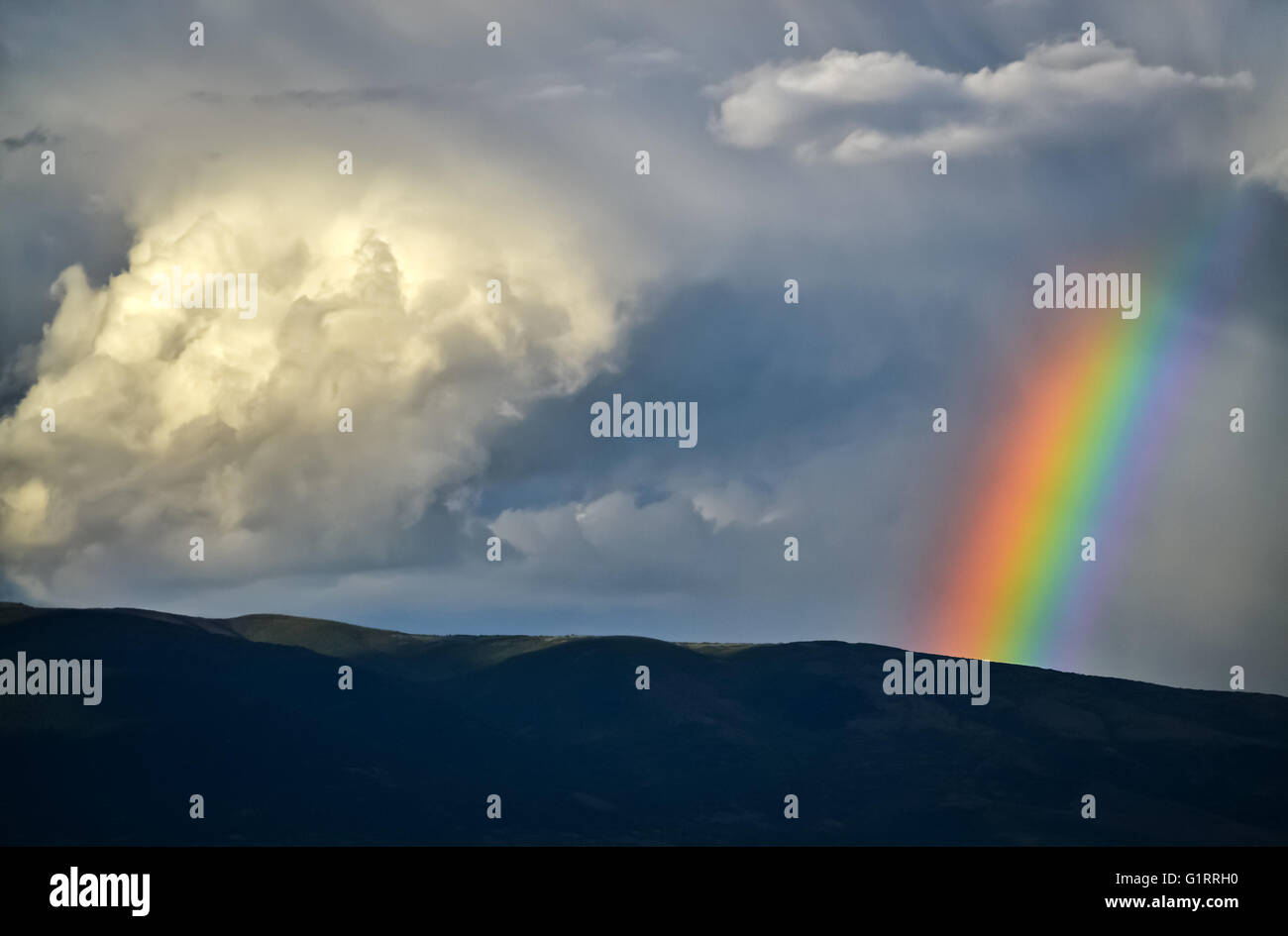 Beautiful rainbow and dense clouds after the rain Stock Photo - Alamy