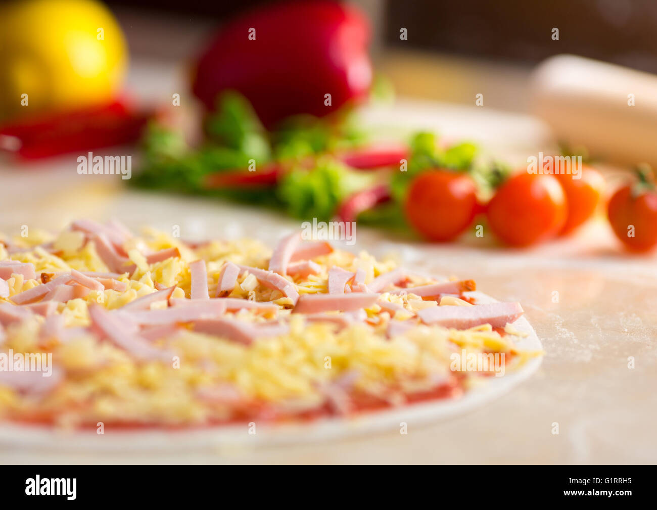Pizza with ham preparation Stock Photo - Alamy