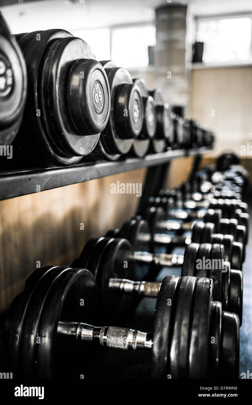Sport Background. Rack of dumbbells in health club. Shelf with metal on ...