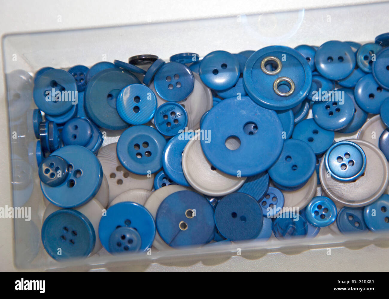 Box of blue buttons, London Stock Photo - Alamy