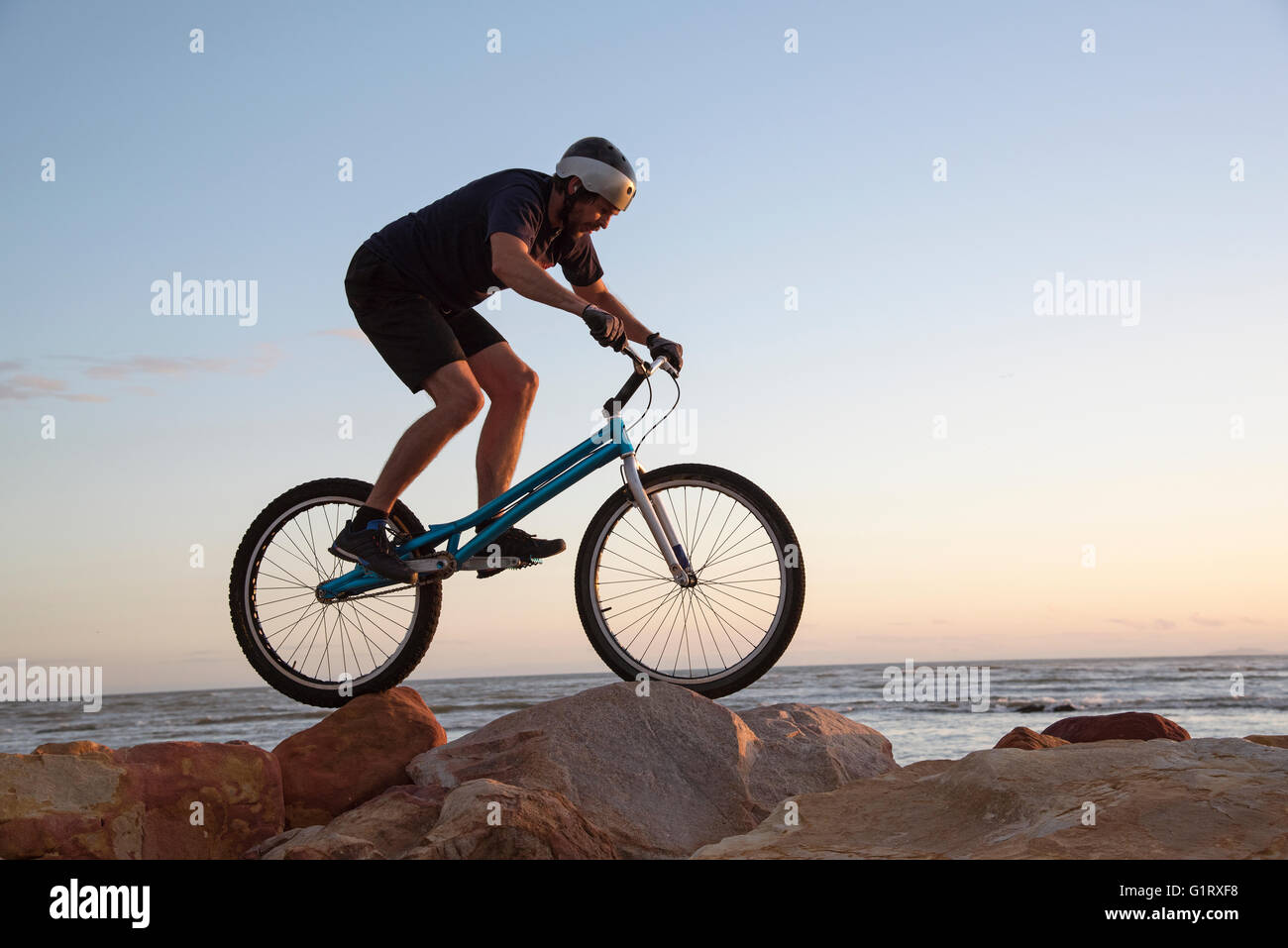 THE STRAND WESTERN CAPE SOUTH AFRICA. A mountain bike rider skillfully ...