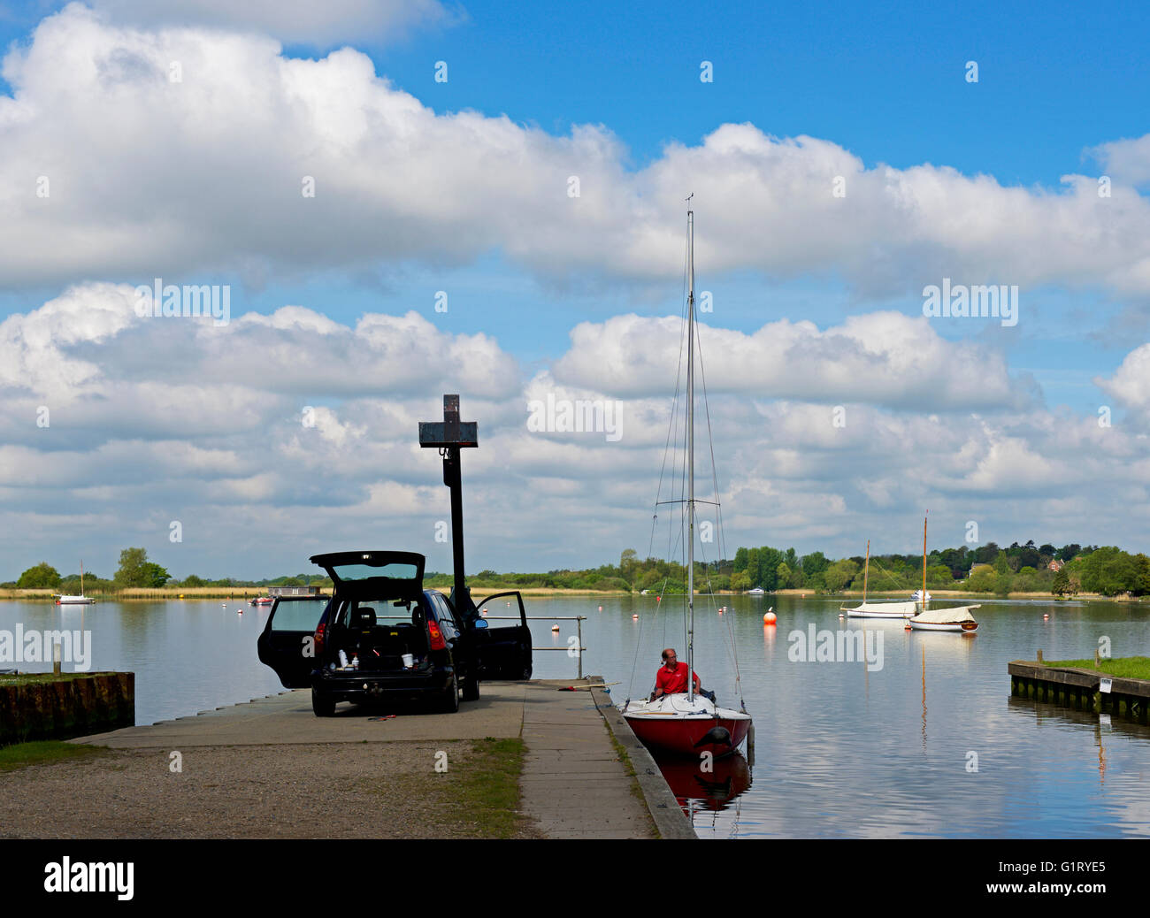 Man with sailing boat, Oulton Broad, Norfolk Broads National Park ...