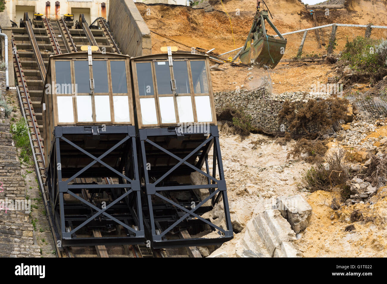 Rubble being cleared by crane after landslide at East Cliff ...