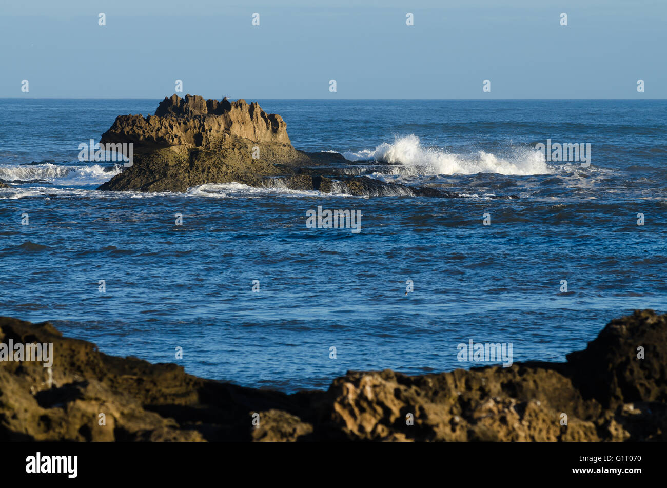 Beautiful beach landscape with big red rocks Stock Photo - Alamy