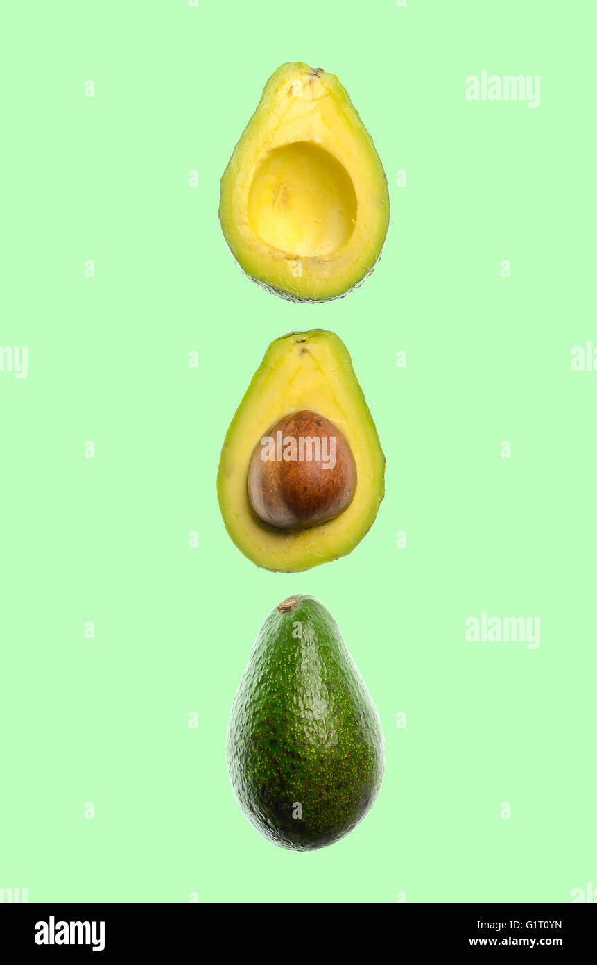 Food silhouette of peeled avocado on isolated light green background ...