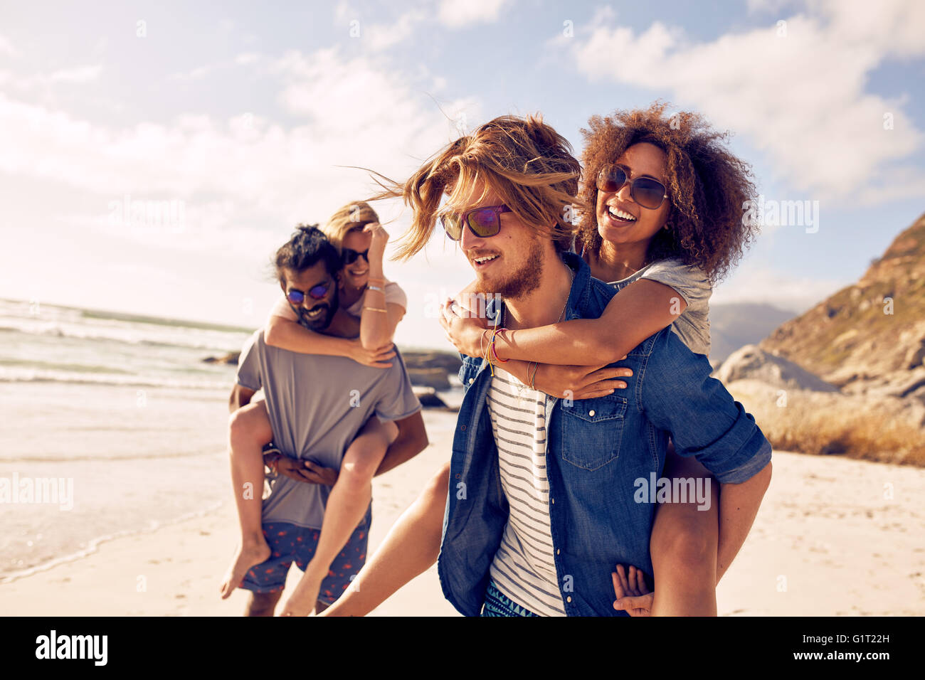 Happy diverse couple playing piggyback hi-res stock photography and ...