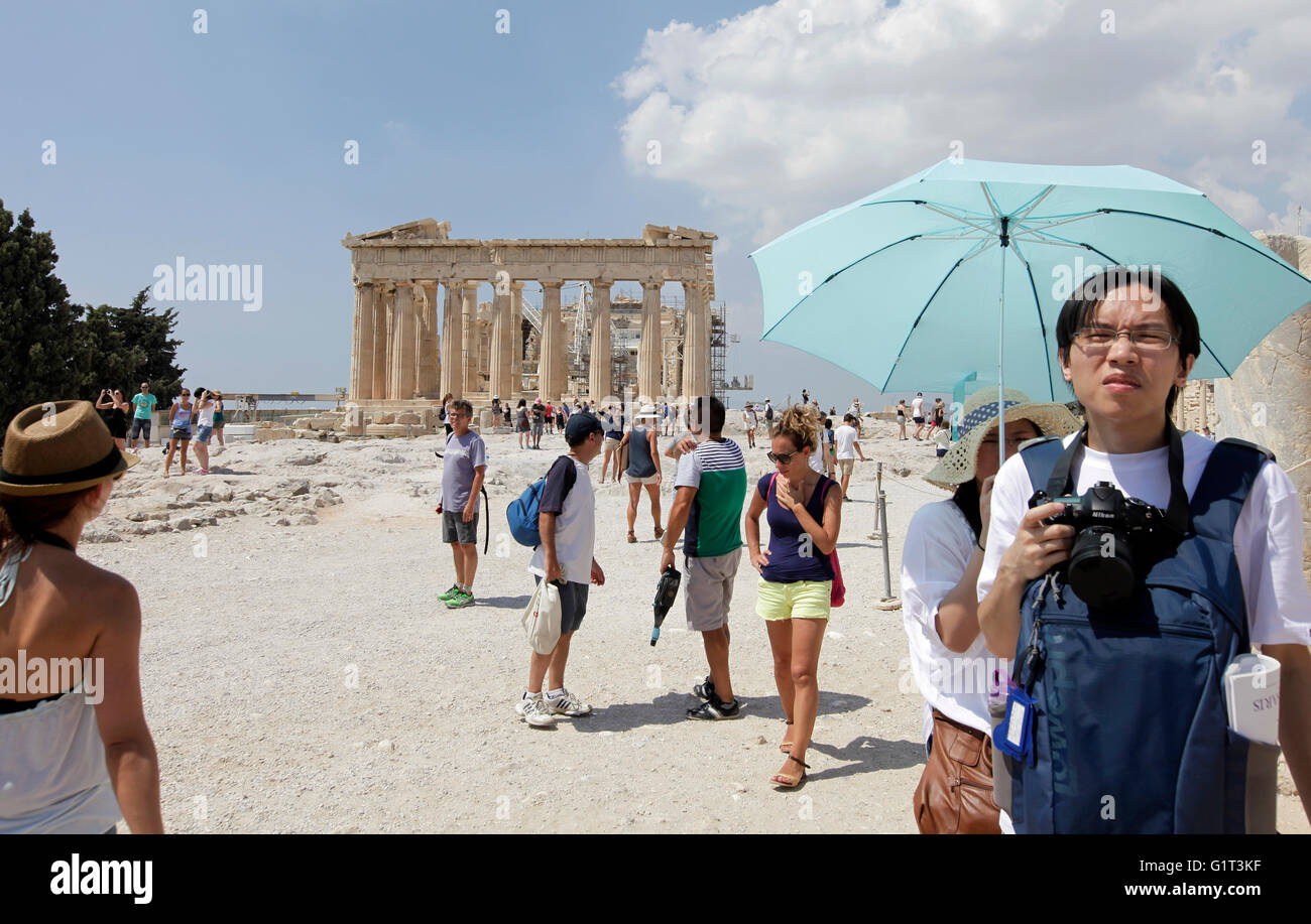 The Parthenon in Athens with tourists taking interest in the ancient ...