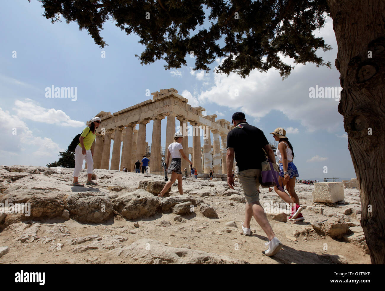 The Parthenon in Athens with tourists taking interest in the ancient ...
