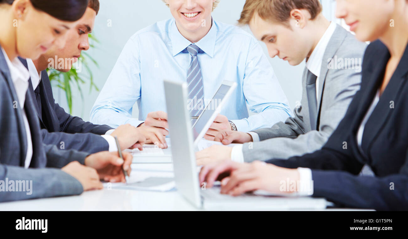 Working in group Stock Photo - Alamy