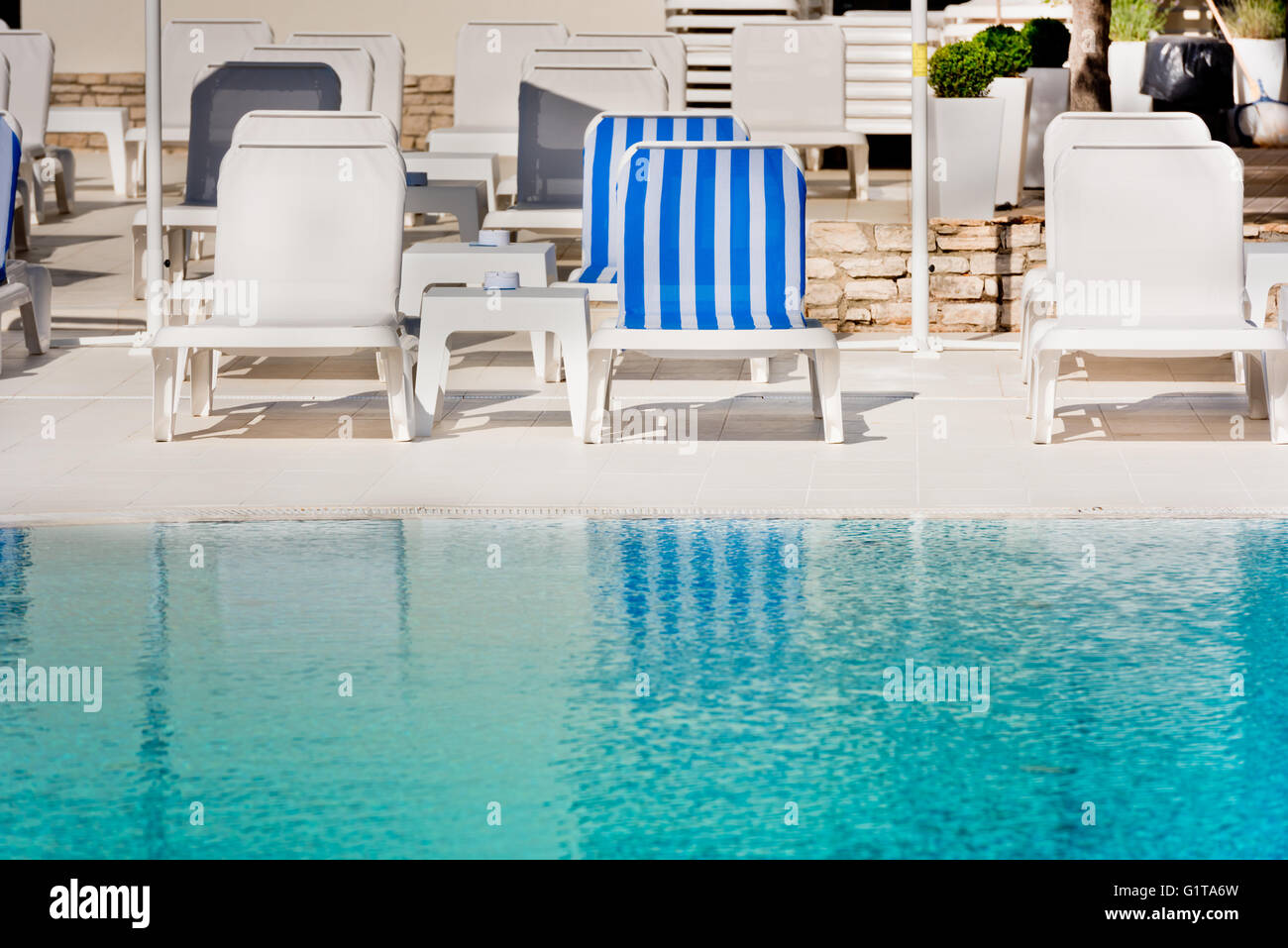 Hotel Poolside Chairs near a swimming pool. Summer shot Stock Photo - Alamy