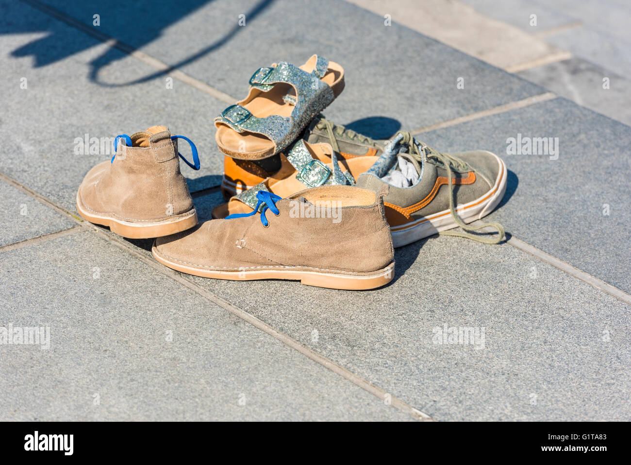 Family Shoes left on a pavement in a street. Horizontal shot Stock ...