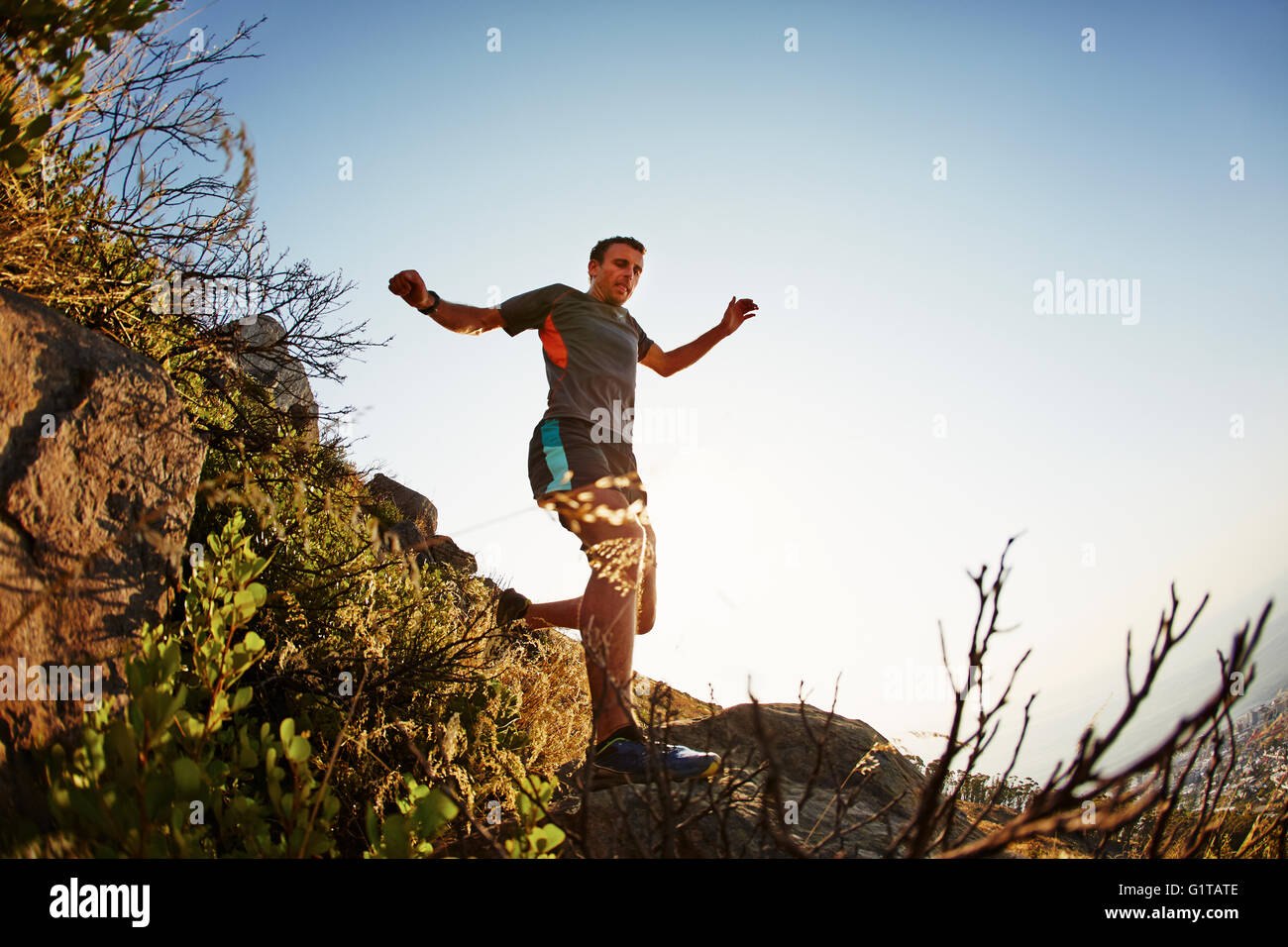 Male runner jumping and descending trail Stock Photo - Alamy