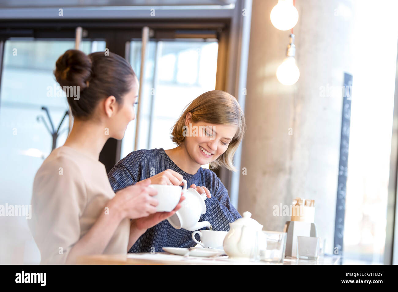 Women drinking tea in cafe Stock Photo - Alamy