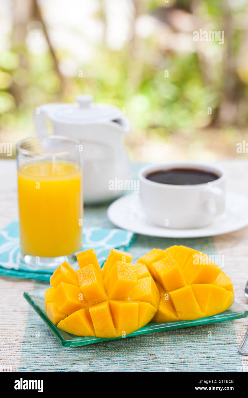 Healthy breakfast Fresh tropical fruit mango and orange juice, coffee ...