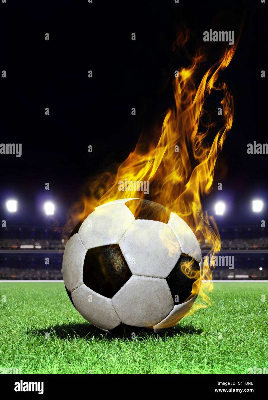 fiery soccer ball on playing field of stadium Stock Photo - Alamy