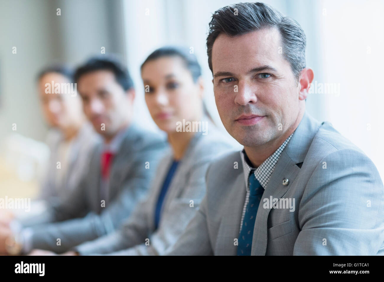 Portrait of confident businessman and colleagues in a row Stock Photo ...