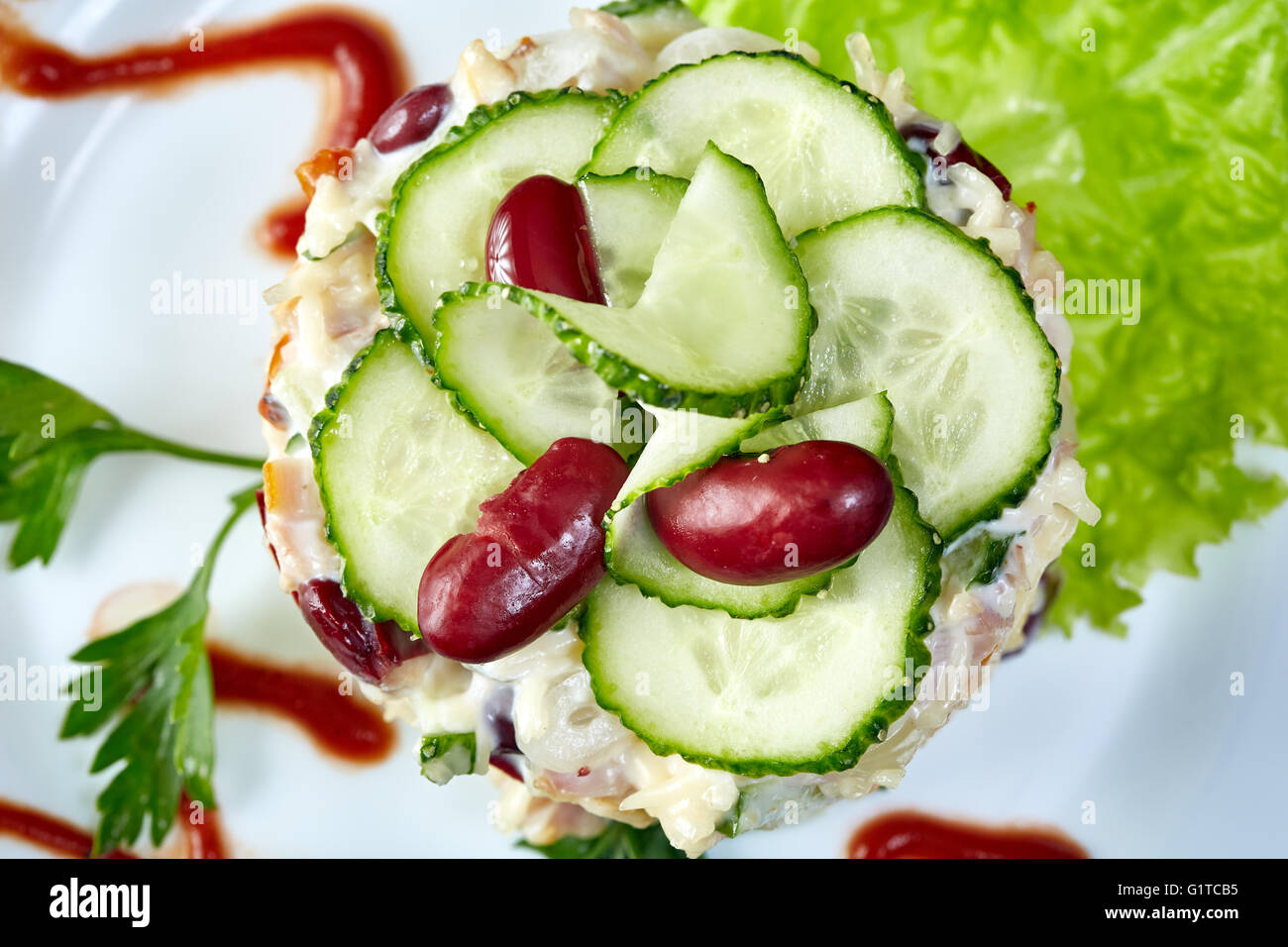 Delicious salad decorated with cucumber and beans Stock Photo - Alamy