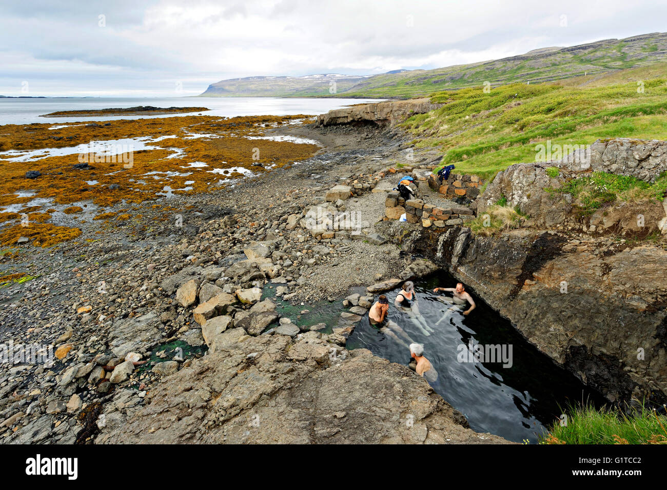 Group of people bathing in a natural thermal spring ( Hellulaug ...