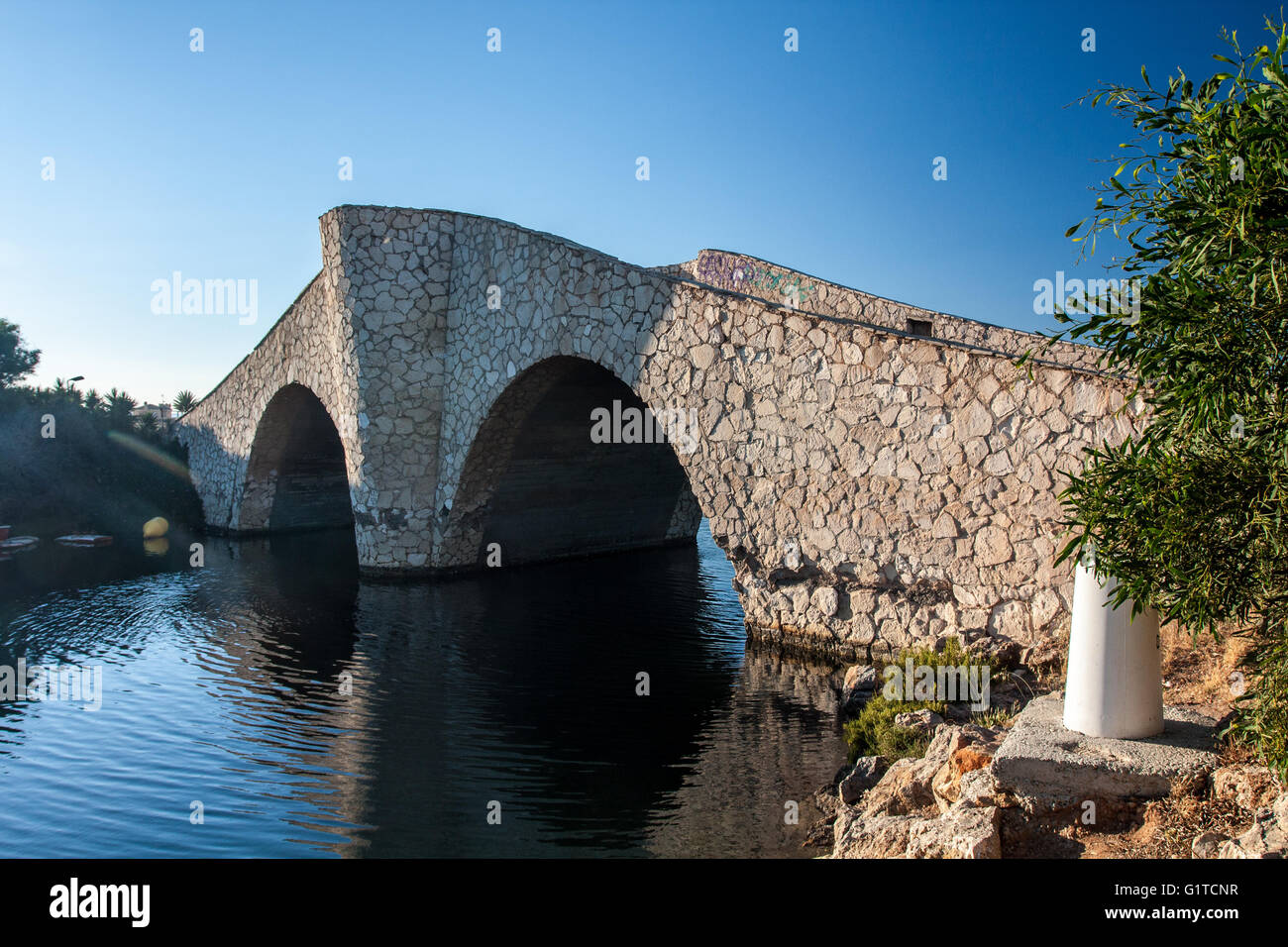 Small stone river bridge with blue sky Stock Photo - Alamy