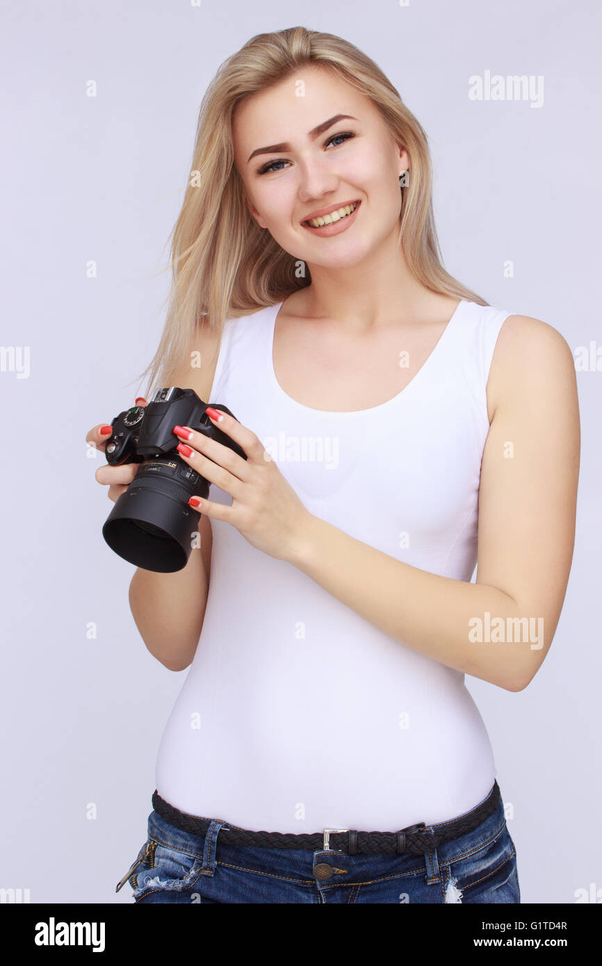 Happy woman holding camera Stock Photo - Alamy