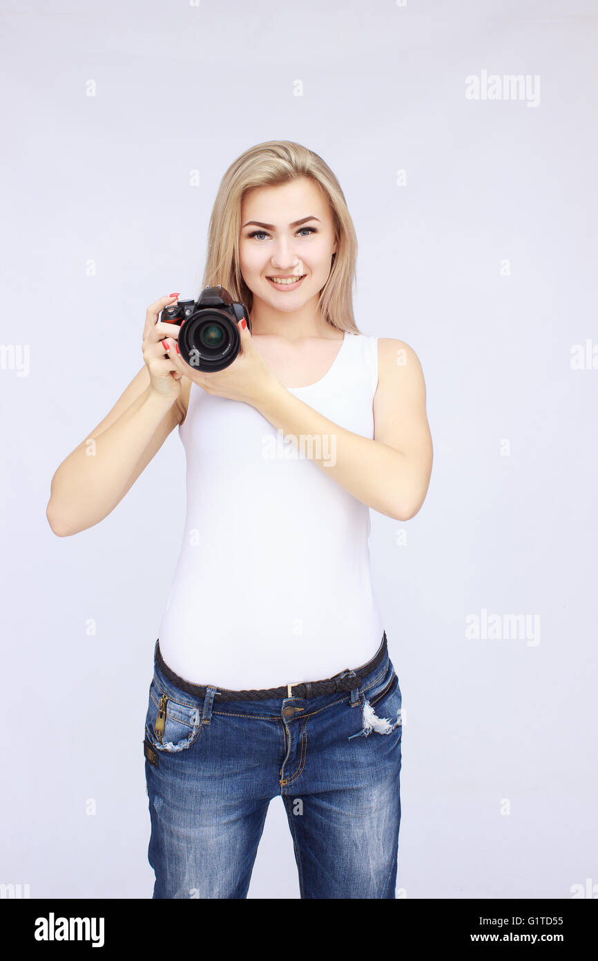 Happy woman holding camera Stock Photo - Alamy