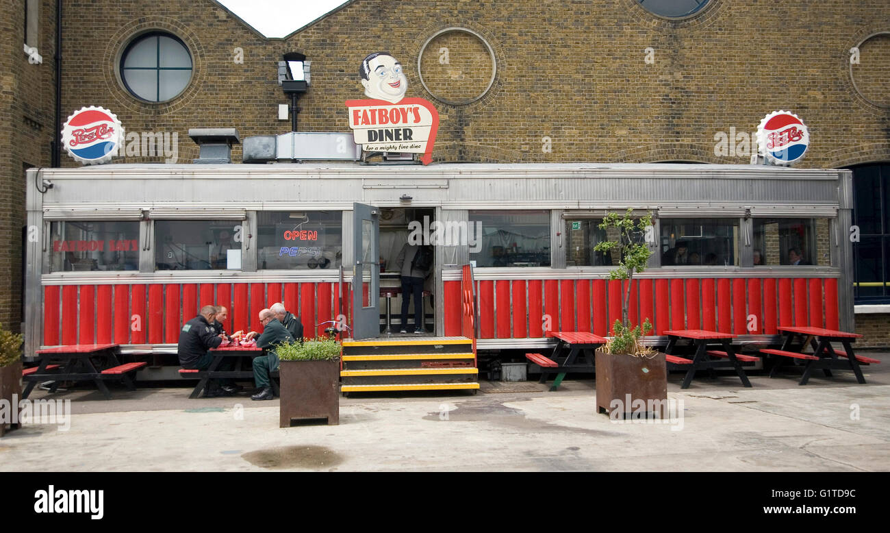 People eat outside Fat Boy's Diner in Trinity Buoy Wharf, east London ...