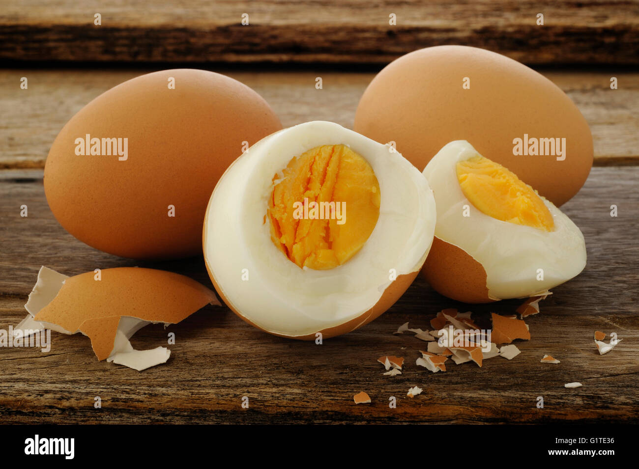 Egg boiled on old wooden background Stock Photo - Alamy