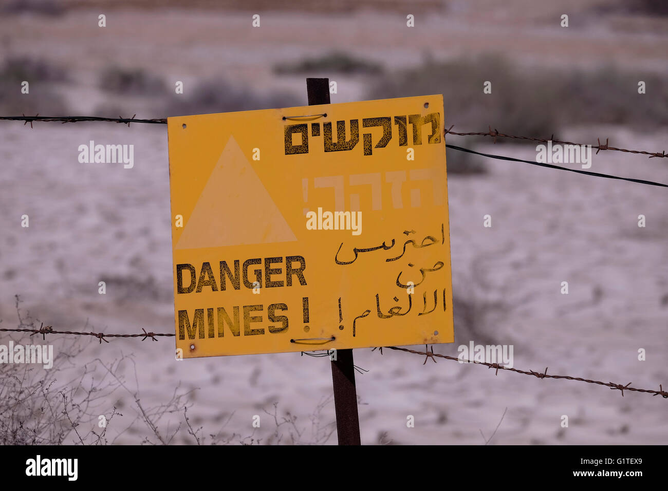 Minefield warning sign in Hebrew English and Arabic at "The land of ...