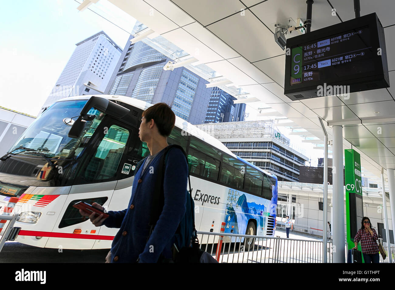 A man walks around the departure area of the Shinjuku Expressway Bus ...
