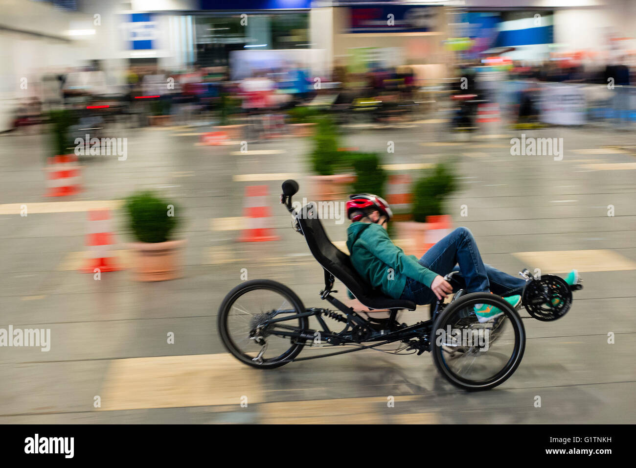 Berlin, Germany. 16th Apr, 2016. A visitor tests a recumbent bicycle at ...