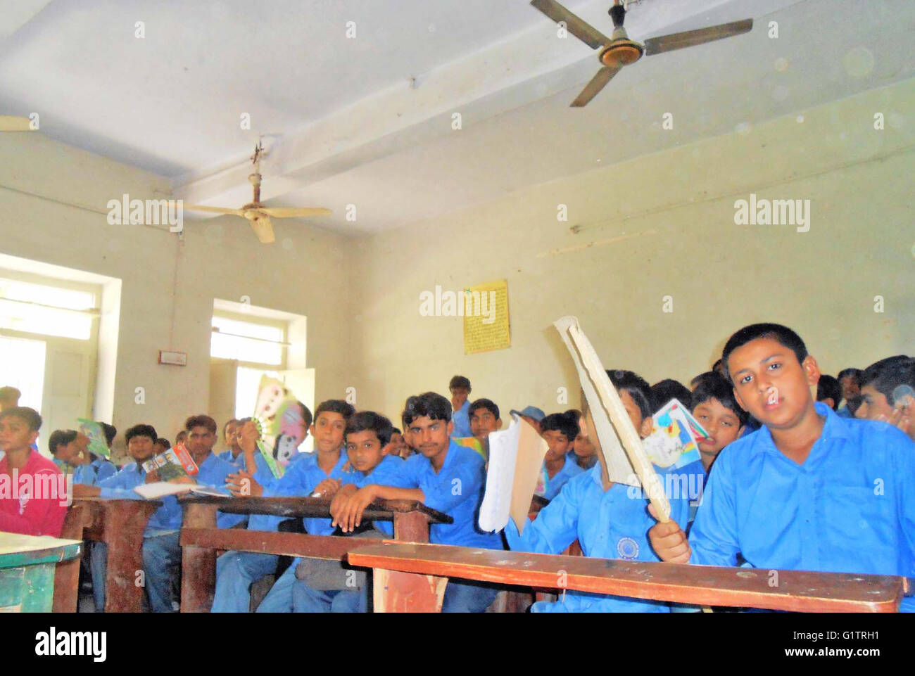 Children using hand fans during classes while prolong load shedding at ...