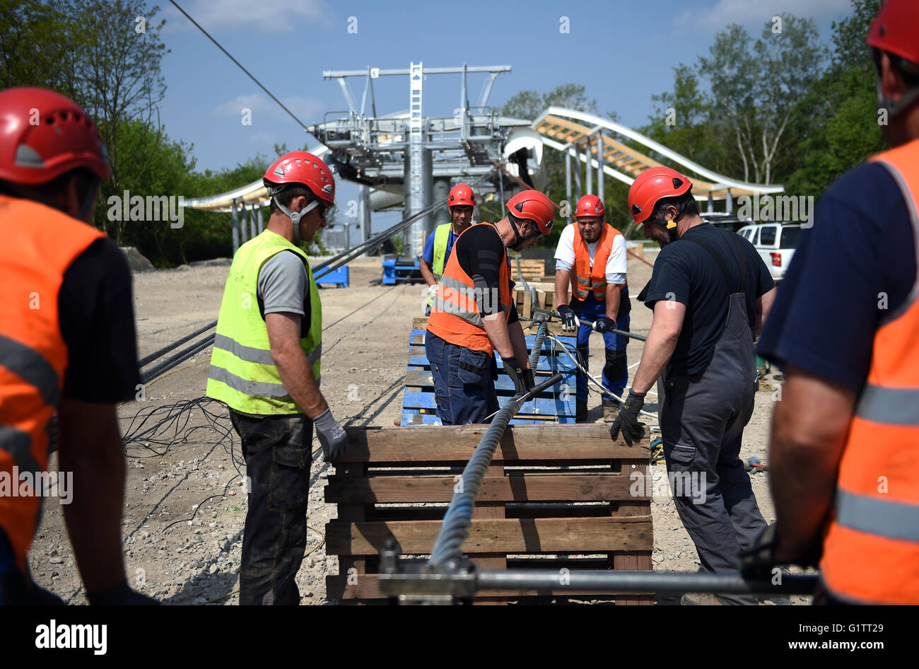Workers splice the control wire for the cable car at the construction ...