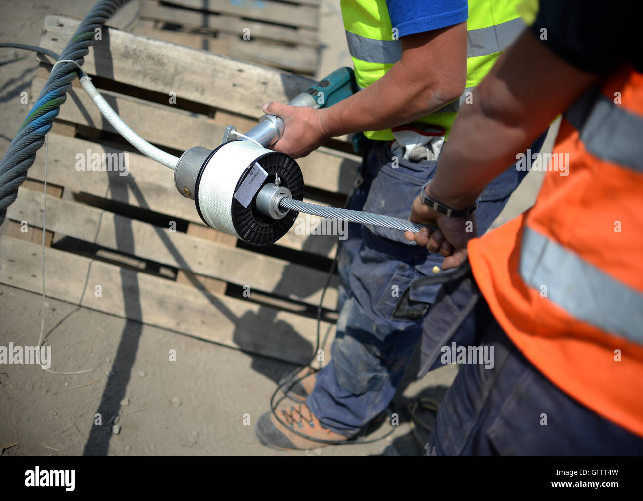 Workers splice the control wire for the cable car at the construction ...