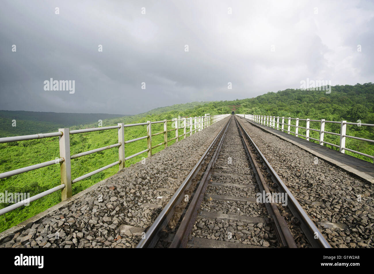 Perspective view of a railway track and tunnel in rainy season, Near ...
