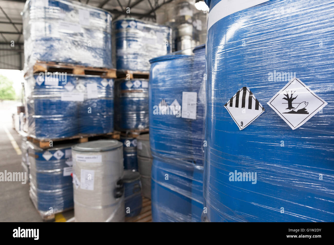 Waste barrels with hazard warning symbols in the warehouse Stock Photo ...