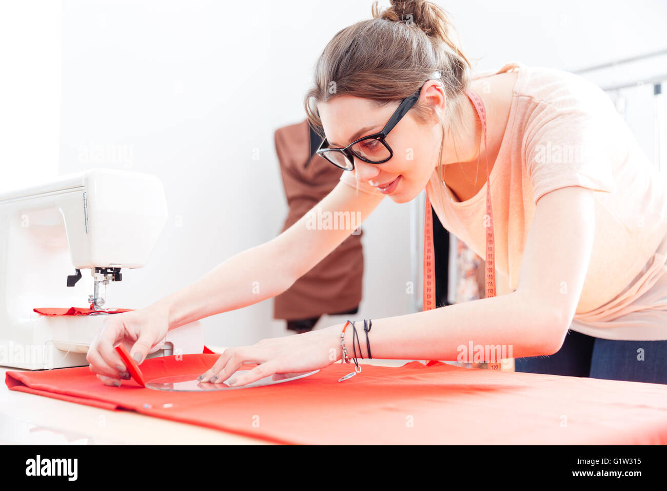 Focused woman tailoring red dress hi-res stock photography and images ...