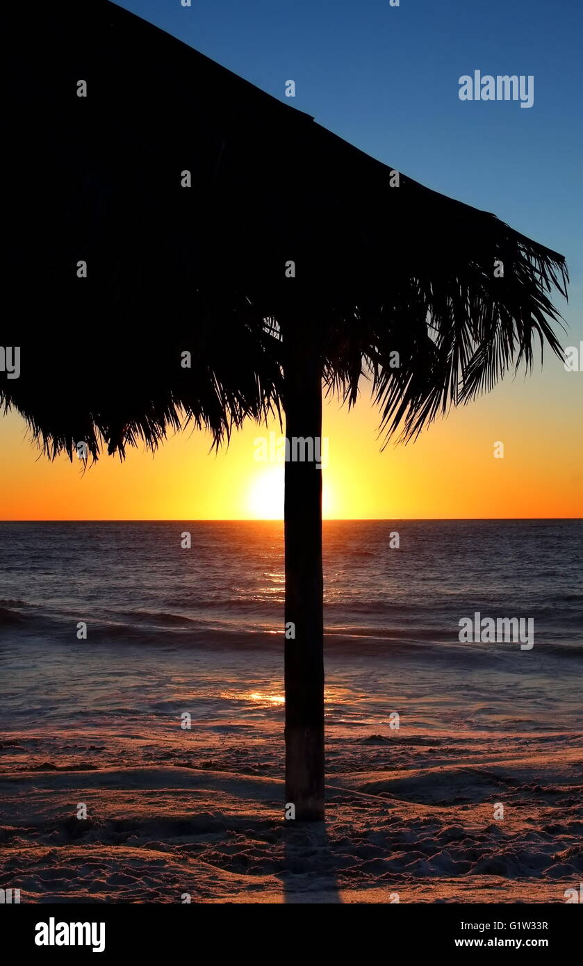 Tiki hut - Tiki hut on beach as the sunset Stock Photo - Alamy