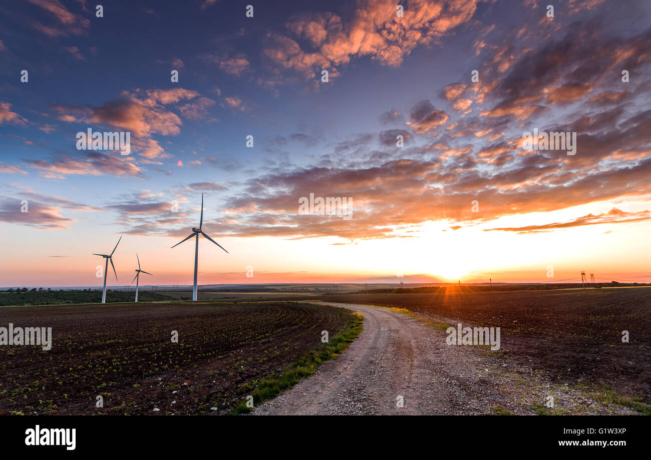 Wind turbines with power line in the sunset! Stock Photo - Alamy