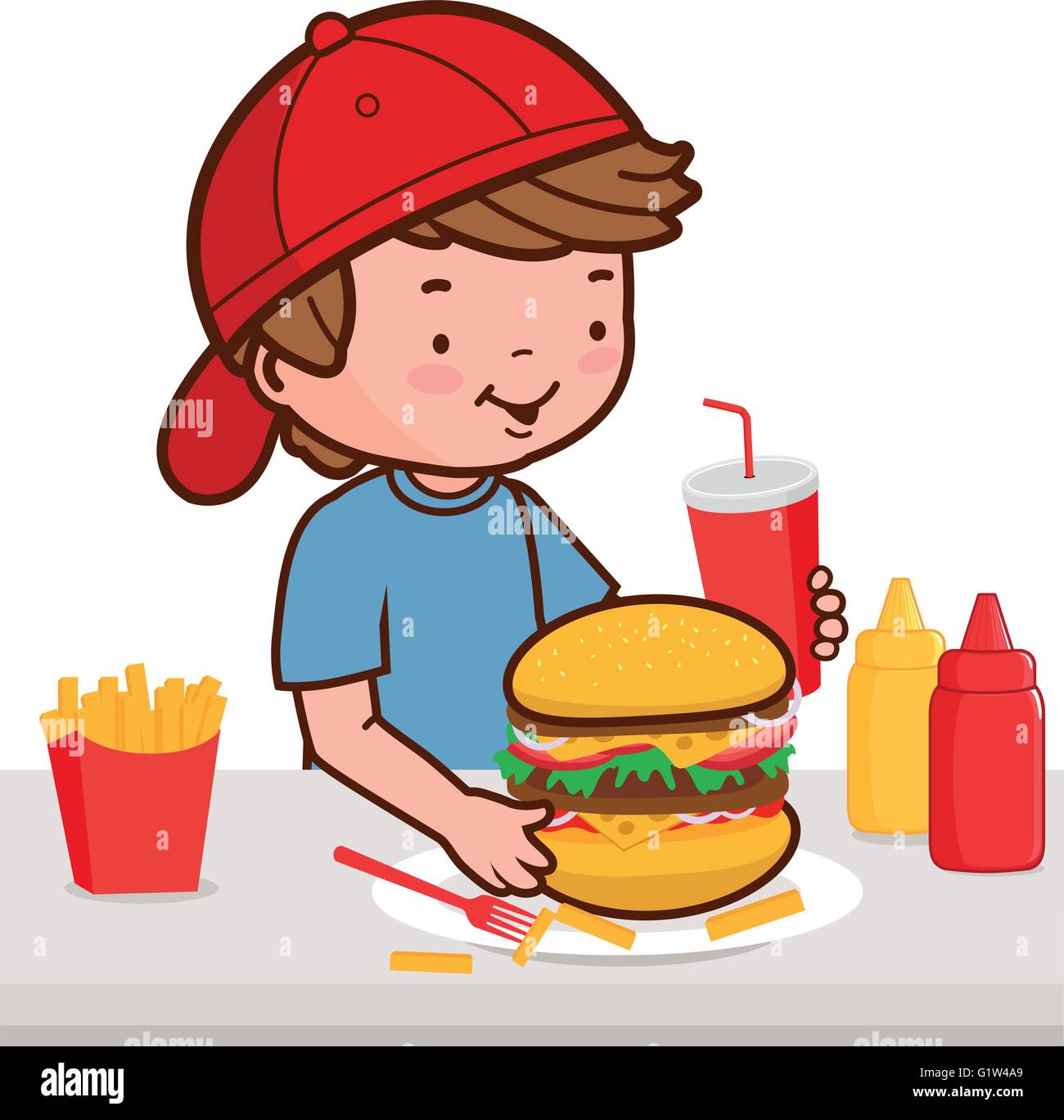 A boy having his fast food meal, eating a hamburger, fries, and ...