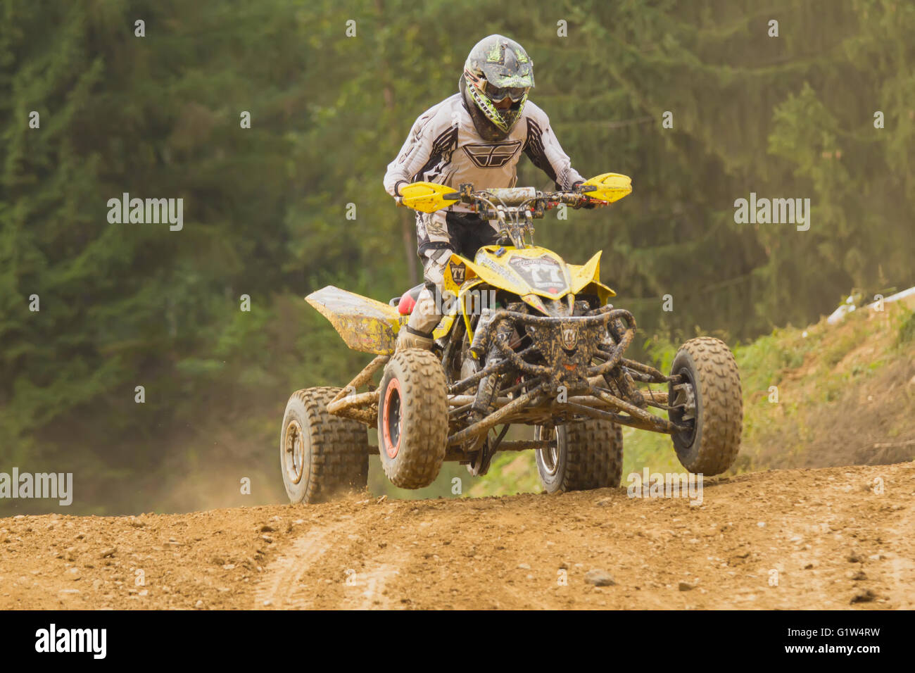 Racer rides a yellow quad motorbike in the race Stock Photo - Alamy