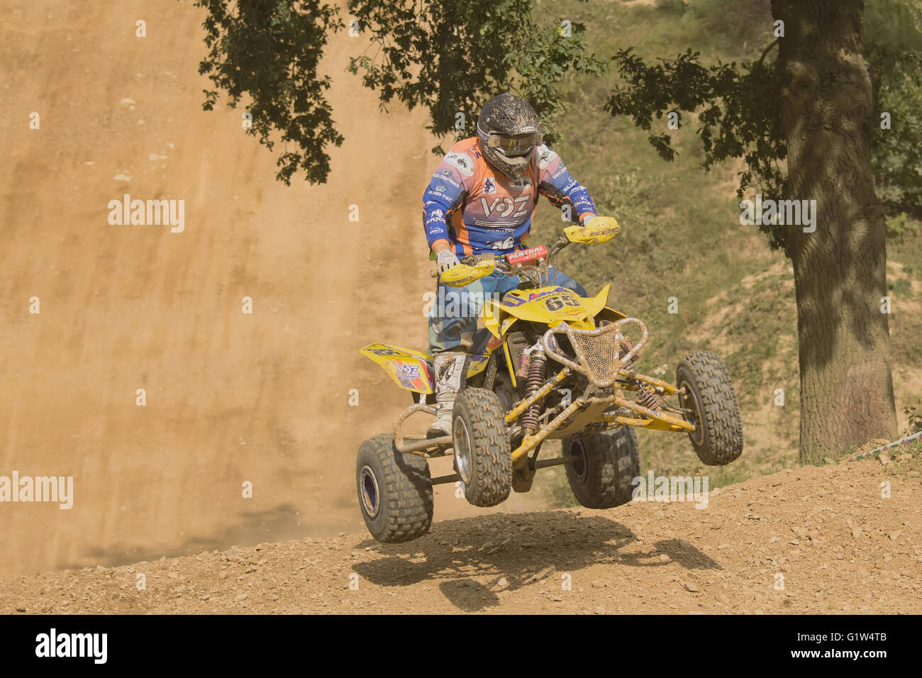Quad racer rides a quad motorbike in the difficult terrain Stock Photo ...
