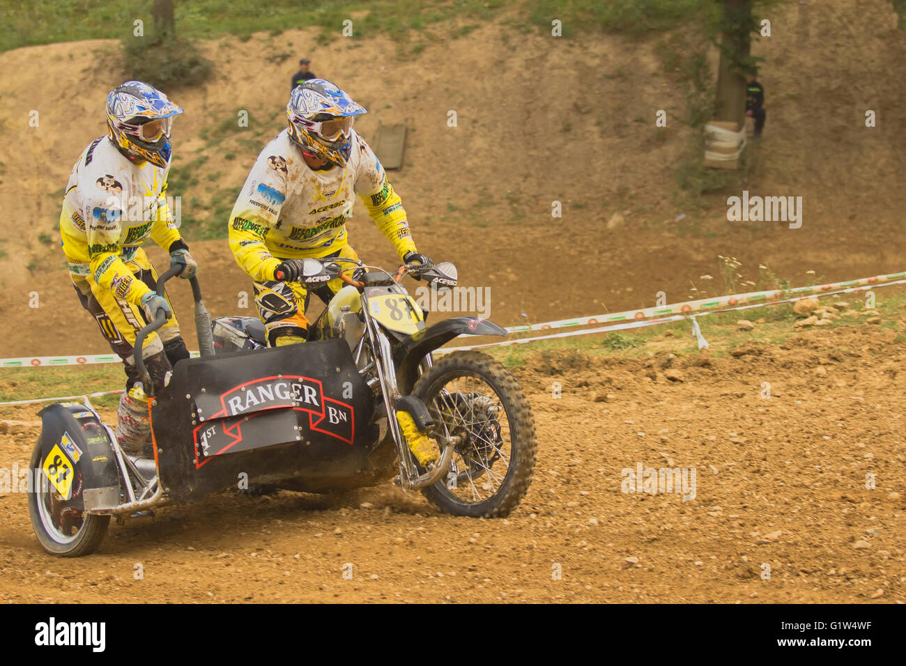 Two racers in yellow ride a sidecar motorbike Stock Photo - Alamy