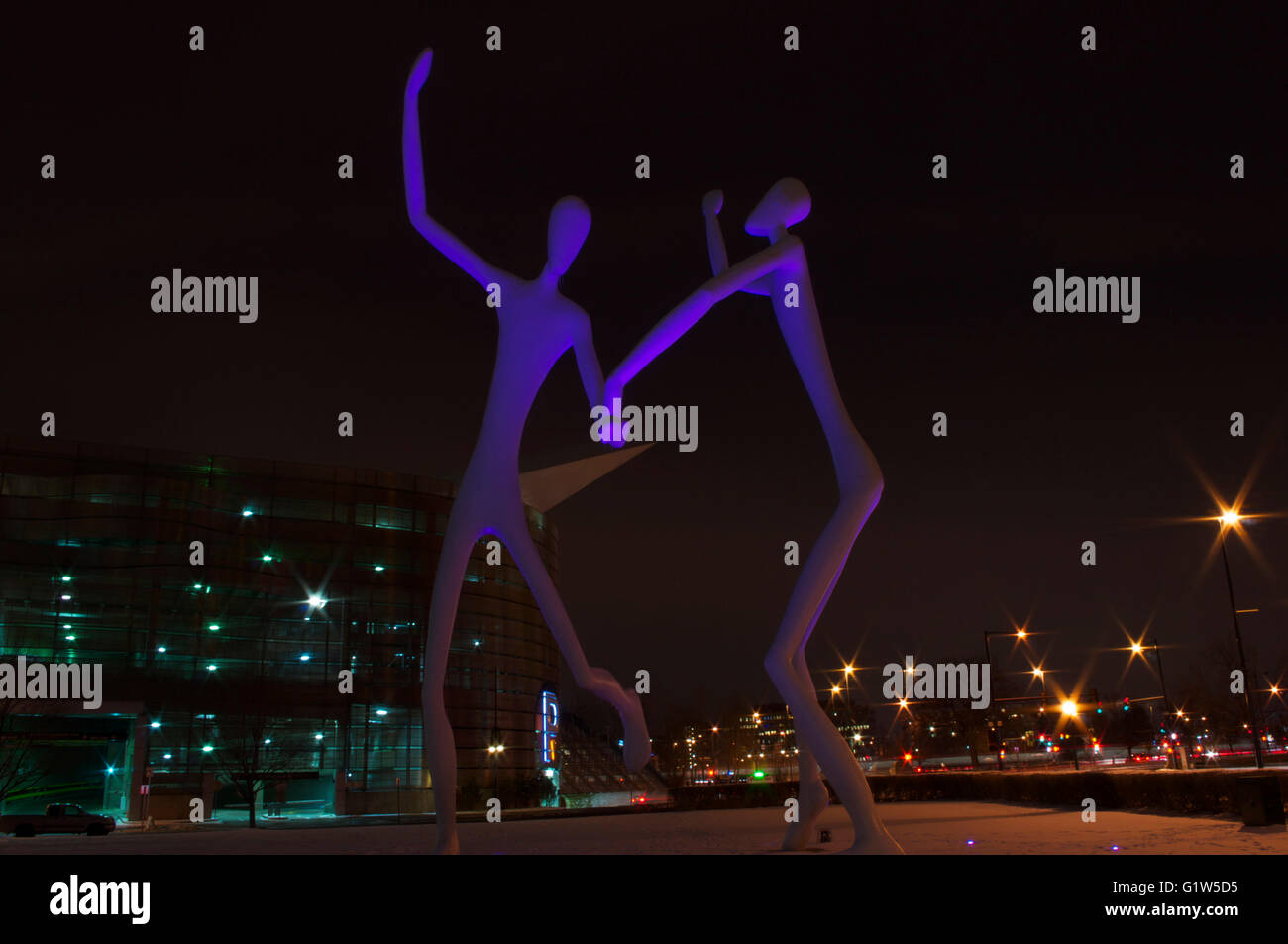 Night photo of purple dancing statues in Denver Colorado Stock Photo ...