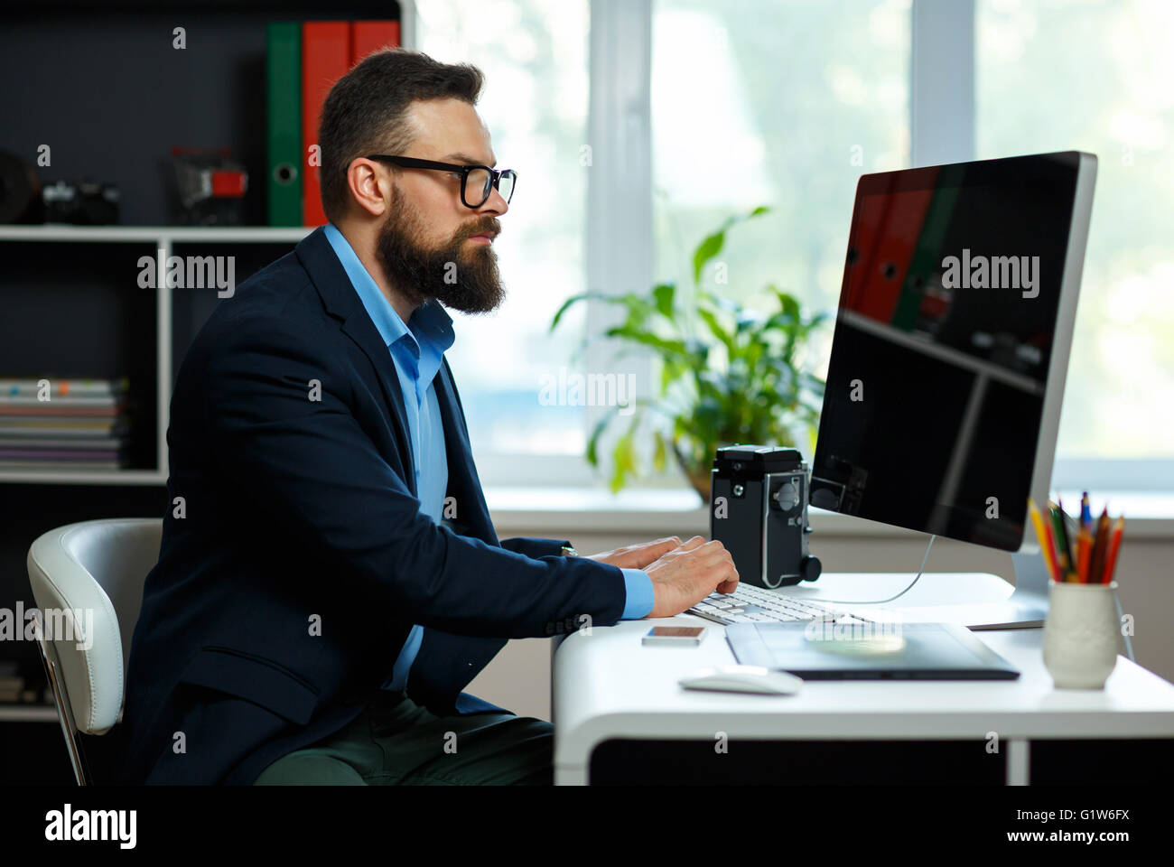 Handsome young man working from home office - modern business concept ...