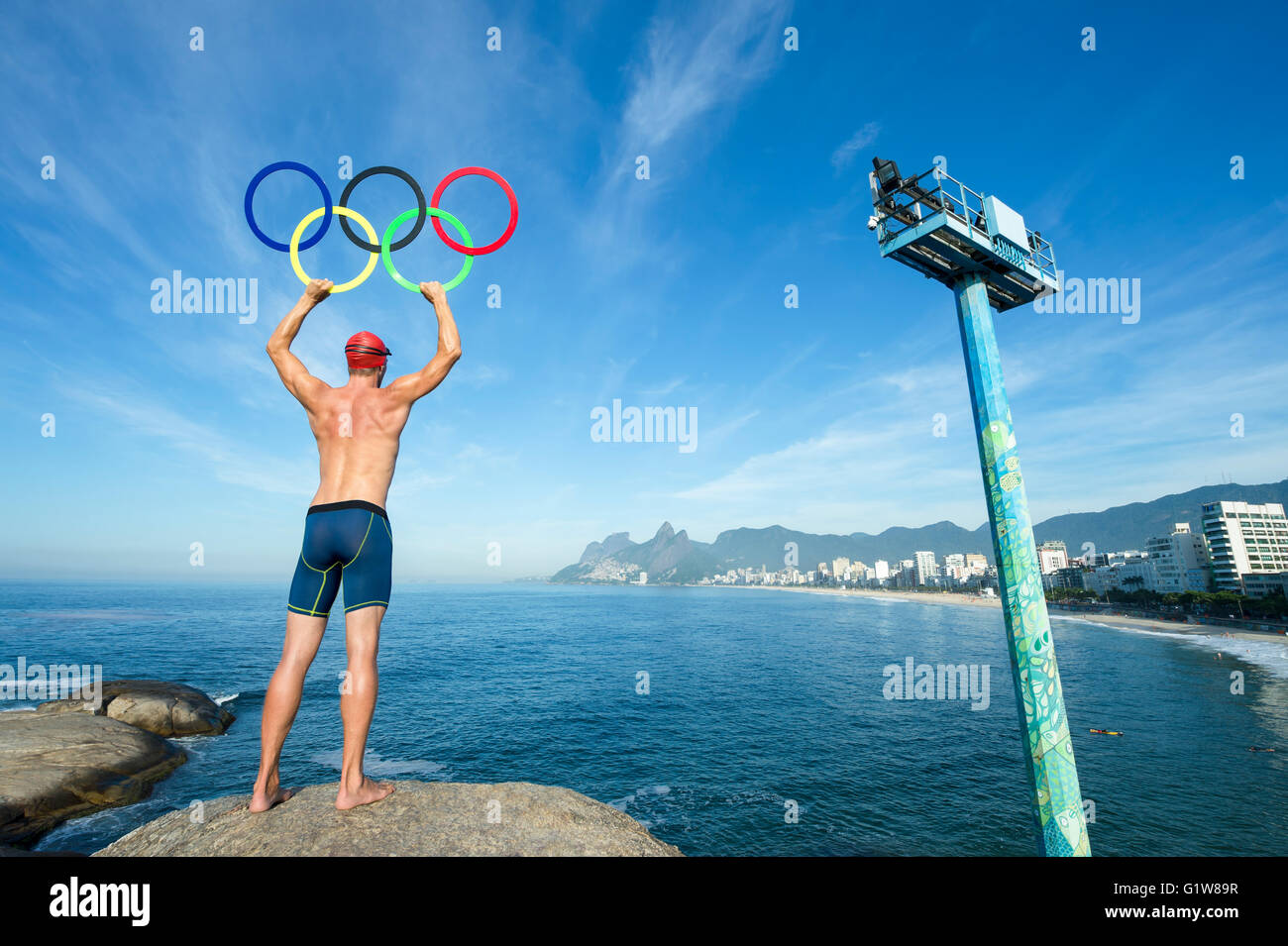 RIO DE JANEIRO - MARCH 27, 2016: Swimmer athlete holds Olympic rings ...