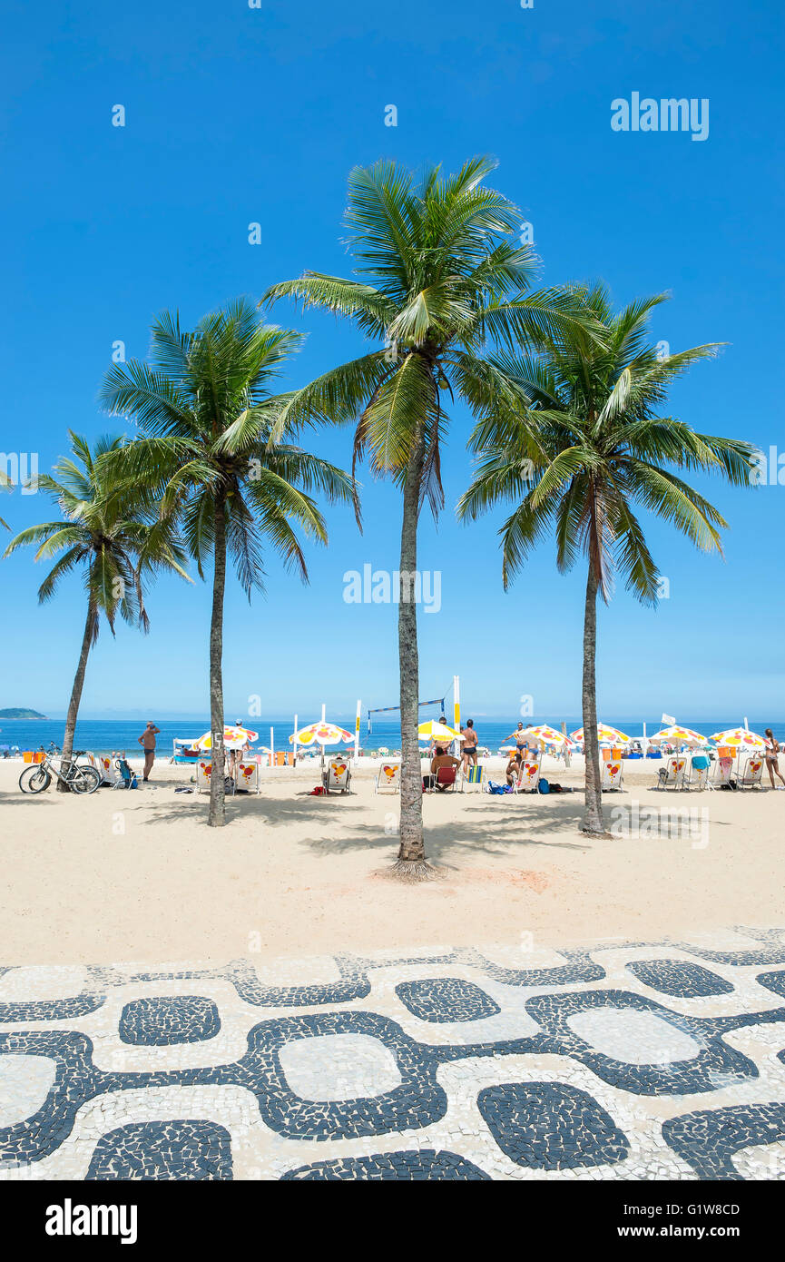 Classic view of Ipanema Beach Rio de Janeiro boardwalk with palm trees ...