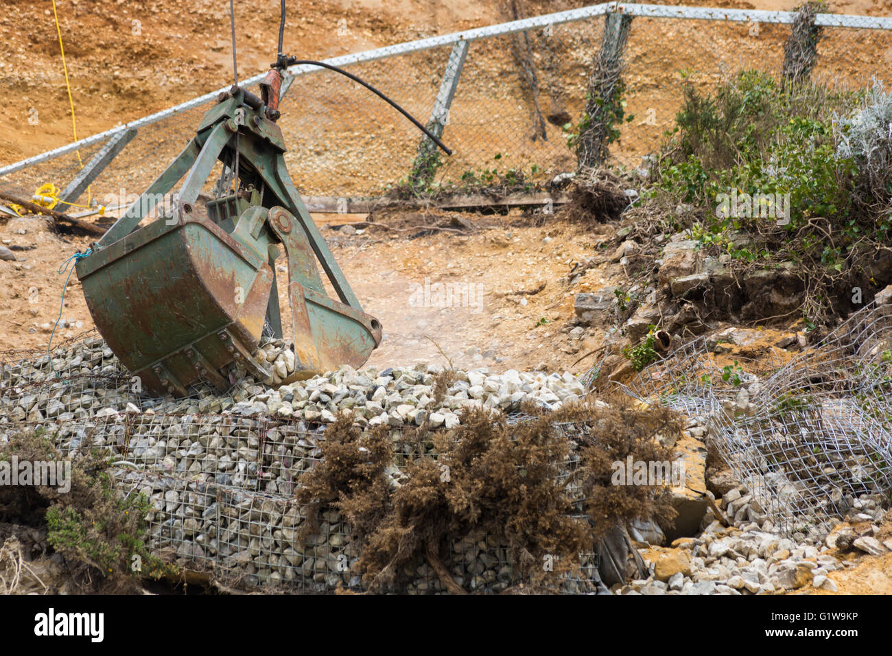 Rubble being cleared by crane after landslide at East Cliff ...