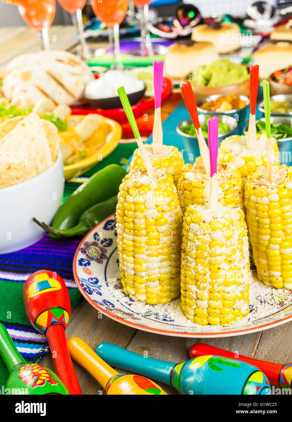 Fiesta party buffet table with spicy mexican corn on the cob and other ...